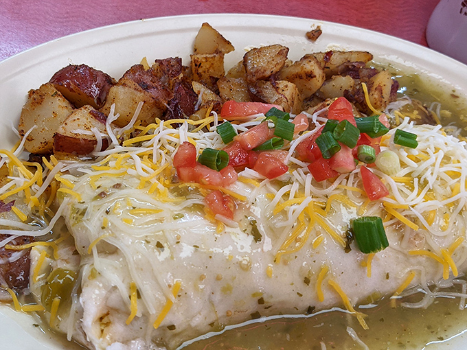 This isn't just breakfast&mdash;it's architecture. Layers of cheese cascade over perfectly wrapped tortilla while crispy potatoes stand guard nearby.