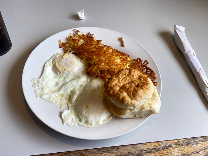Sunny-side up perfection meets golden hash browns and a fluffy biscuit. This breakfast trinity doesn't need fancy presentation to make your morning better.