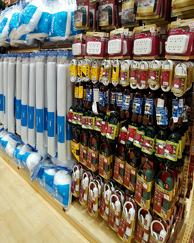 Extension cords and power strips hang like technological vines in this jungle of electrical necessities&mdash;modern life's essential connectors at bargain prices.