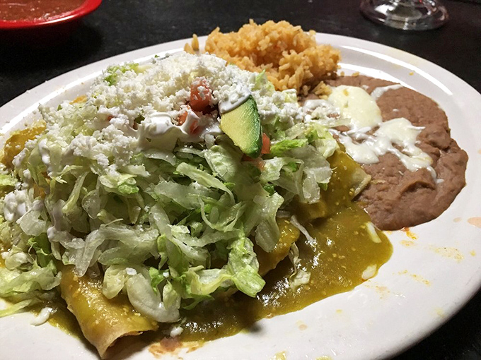 This enchilada arrives dressed for success &ndash; smothered in verde sauce and topped with enough lettuce and queso fresco to make vegetables feel like a celebration.