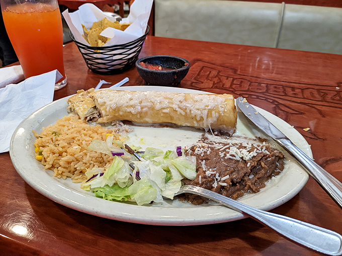 This isn't just a burrito—it's a hand-rolled masterpiece of flavor, accompanied by the golden rice that dreams are made of.