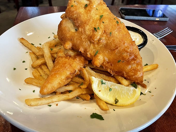 Golden, crispy perfection meets flaky, tender fish. This isn't just fish and chips; it's edible poetry served with a lemon wedge.