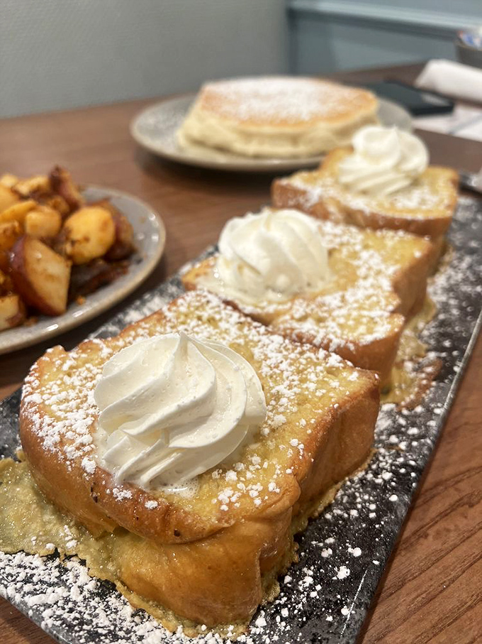 Golden slices of French toast dusted with powdered sugar and topped with perfect dollops of cream &ndash; proof that simplicity can be stunning.