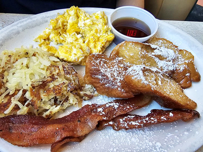 Breakfast nirvana on a plate! Perfectly crisp hash browns steal the show alongside fluffy eggs, while French toast dusted with powdered sugar awaits its maple bath.