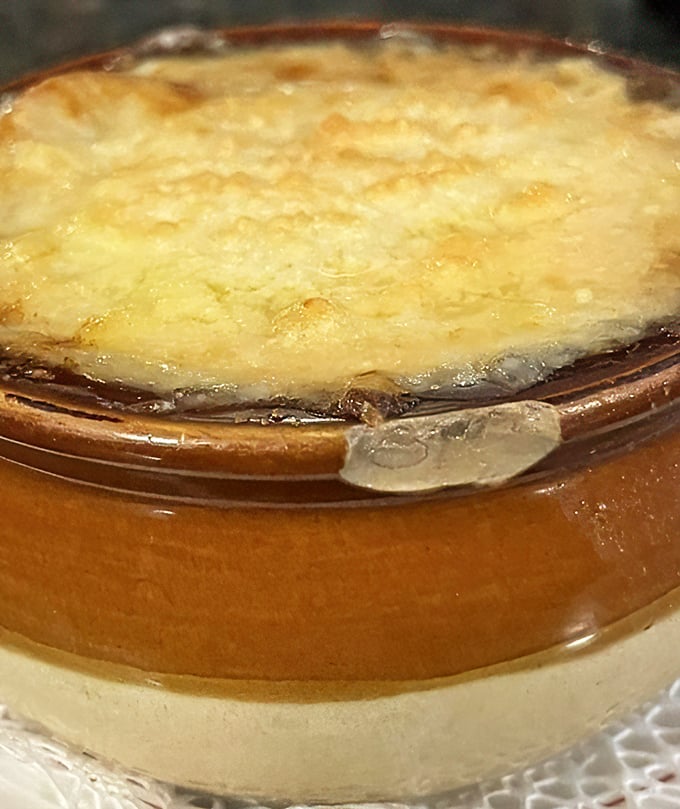 Behold the holy grail of comfort food! This French onion soup's cheese cap is the superhero cape your taste buds didn't know they needed.