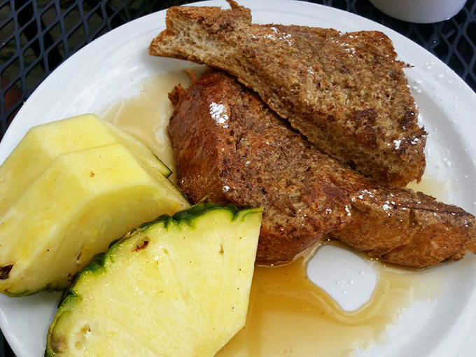 Golden-brown French toast with a side of fresh fruit&mdash;proof that breakfast perfection exists and it's hiding in Petoskey.