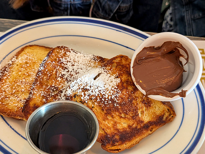 This French toast doesn't just arrive at your table&mdash;it makes an entrance, complete with powdered sugar snowfall and chocolate sidekick.