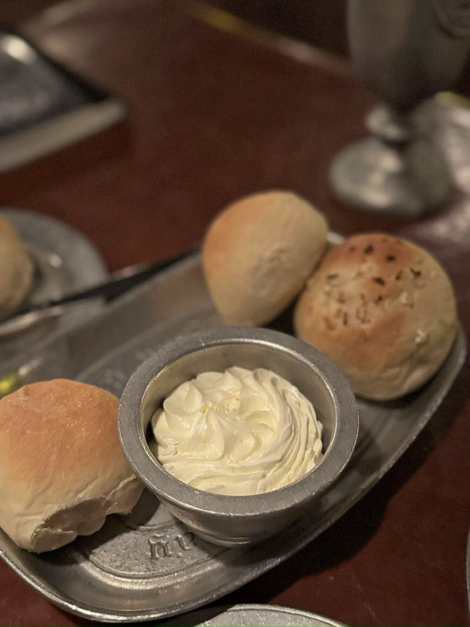 Fresh-baked rolls arrive with whipped butter so light it might float away if not for the gravitational pull of your appetite.