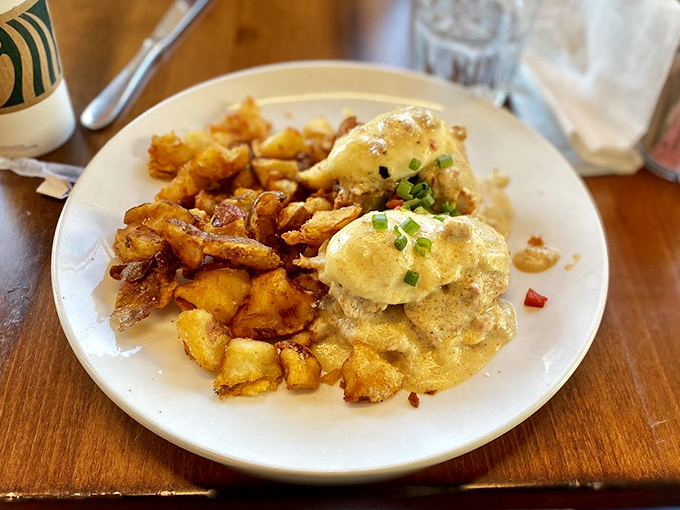 Benedict perfection achieved! Golden potatoes flank poached eggs draped in hollandaise like they're wearing sunshine-colored evening gowns.