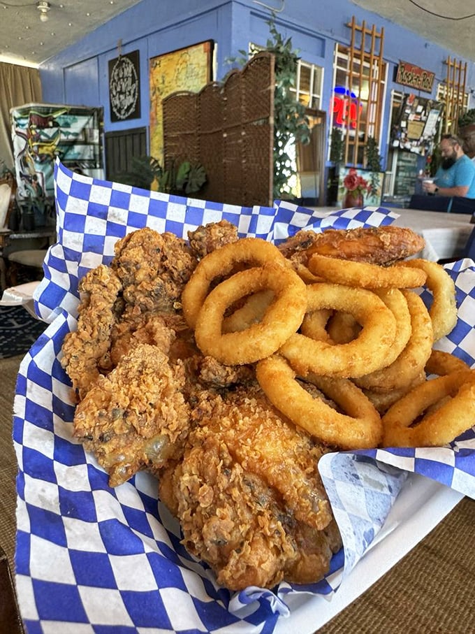 Golden-fried chicken nestled against crispy onion rings&mdash;a blue-checkered basket of pure joy that's worth every mile of the journey.