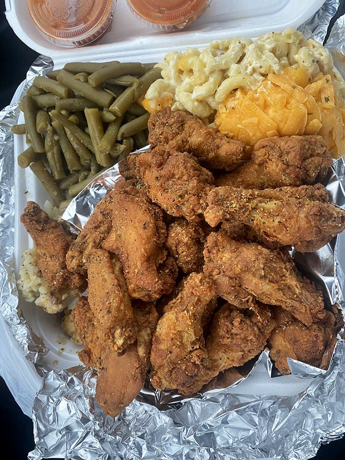 Golden-brown fried chicken that shatters at first bite, surrounded by sides that refuse to accept their supporting role status.