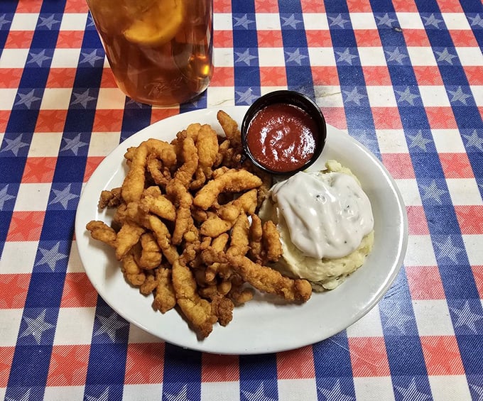 Golden treasures from the deep! These fried clam strips arrive perfectly crisp, ready to be dunked in that tangy sauce like Olympic divers with impeccable form.