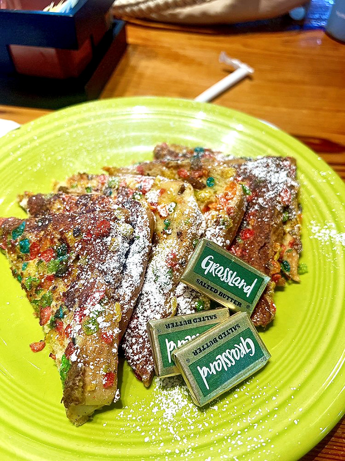 Fruity Pebble French toast that would make Fred Flintstone weep with joy&mdash;childhood nostalgia served on a lime-green plate.