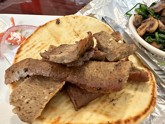 Gyro meat that's been kissed by fire and blessed by seasoning, served on warm pita &ndash; proof that simplicity, when done right, is culinary poetry.