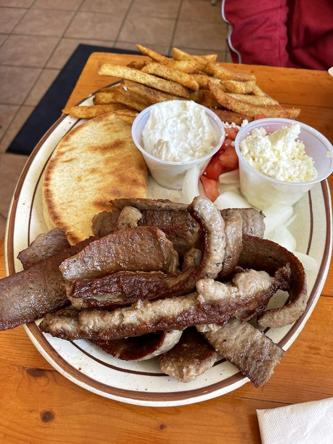 Behold the gyro platter in all its glory &ndash; seasoned meat, warm pita, creamy tzatziki, and golden fries that would make Poseidon himself swim to shore.