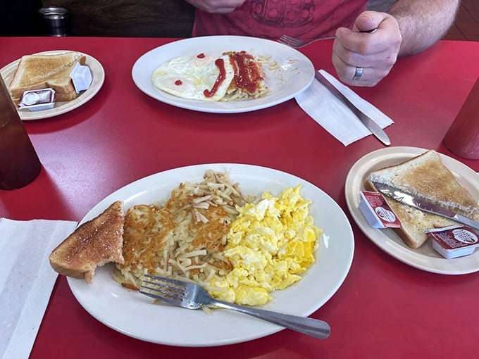 The holy trinity of breakfast perfection: crispy-edged hash browns, sunshine-yellow eggs, and toast waiting patiently for its moment of buttery glory.
