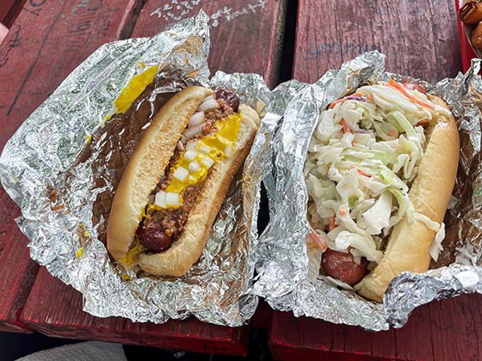 Two West Virginia classics wrapped in foil: a chili dog with mustard and a proper slaw dog. Simple pleasures that speak volumes about local food culture.