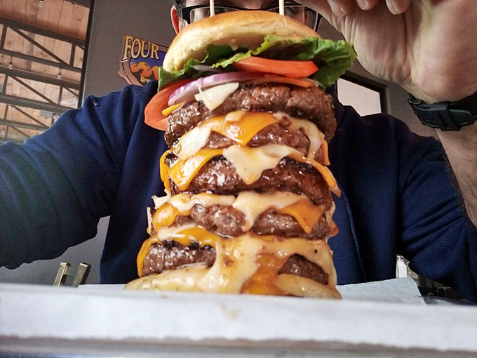 Not so much a burger as a skyscraper of beef and cheese. This towering creation makes you wonder if they employ structural engineers alongside their chefs.