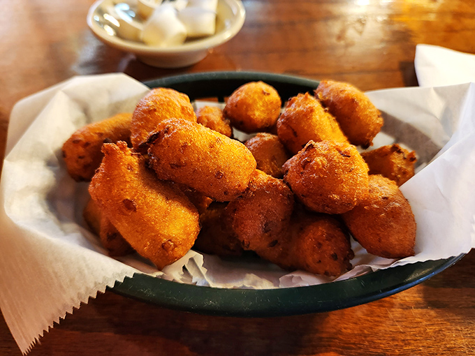 Golden-brown hush puppies that crunch like nature's perfect snack. One bite and you'll understand why people cross county lines for these beauties.