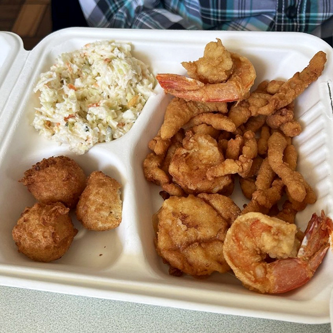 Behold the holy trinity of fried goodness: golden hush puppies, crispy shrimp, and those legendary clam strips that'll haunt your dreams in the best possible way.