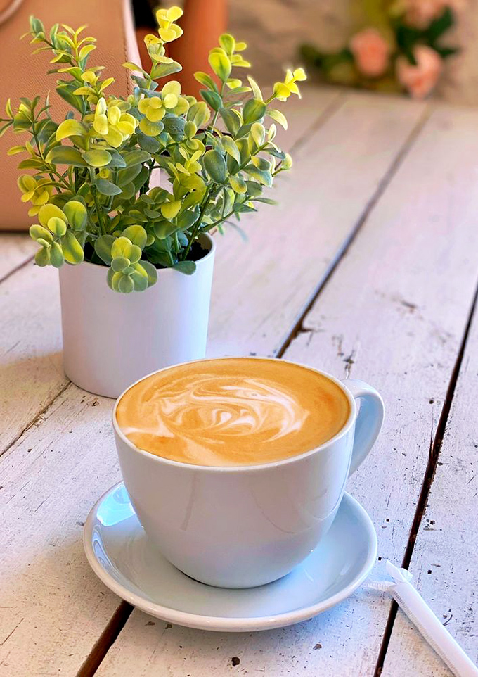 That perfect swirl of latte art beside a splash of greenery&mdash;because sometimes Monday mornings require both beauty and caffeine.