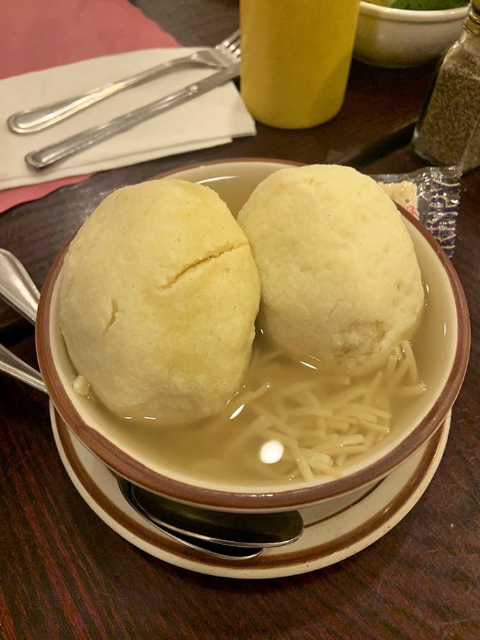 The matzo balls are planetary in proportion, floating majestically in broth like edible moons orbiting your spoon.