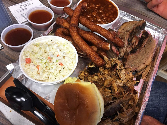 Barbecue nirvana on a tray: pulled pork, tender brisket, golden hush puppies, and sides that refuse to be upstaged by the meat.