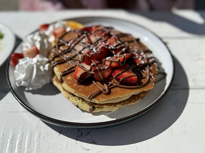 Pancakes adorned with strawberries, chocolate drizzle, and whipped cream&mdash;proof that sometimes the most important meal of the day doubles as dessert.
