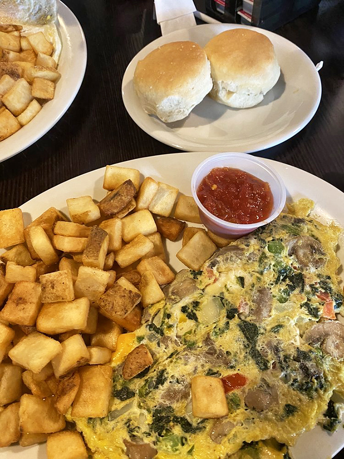 Behold the omelet that requires its own area code, served with enough home fries to feed a small marching band.