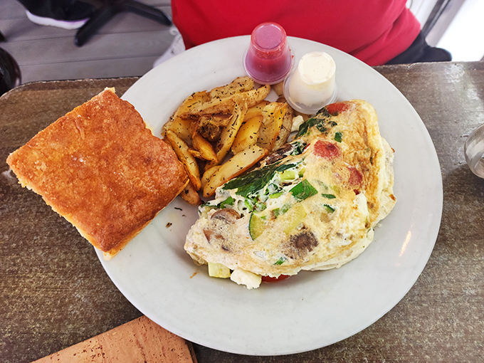 An omelet that doesn't just sit on the plate&mdash;it commands attention. Those country potatoes are the unsung heroes of this breakfast symphony.