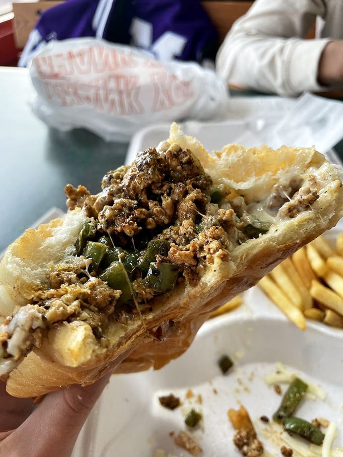 Behold the cross-section of joy &ndash; thinly sliced beef, melted cheese, and green peppers creating the holy trinity of sandwich perfection.