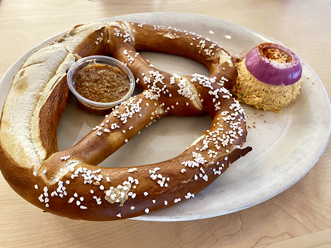 The star of the show arrives: a perfectly bronzed pretzel with mustard and a mysterious orange spread that might just change your life forever.