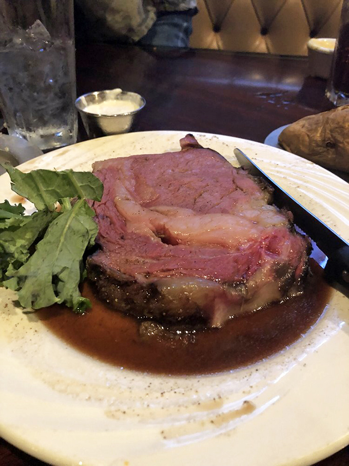 The prime rib doesn't just sit on the plate&mdash;it commands attention, a glistening monument to beef perfection surrounded by a moat of savory au jus.