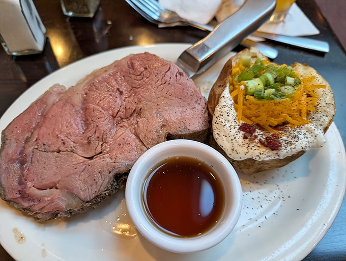 Behold the star of the show: perfectly pink prime rib alongside a loaded baked potato. This is what food dreams are made of.