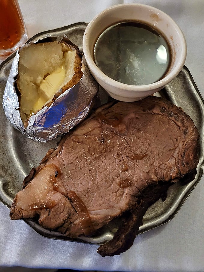 Meat poetry on a metal plate. This perfectly pink prime rib with its butter-drenched potato sidekick is Oklahoma's answer to fine dining.