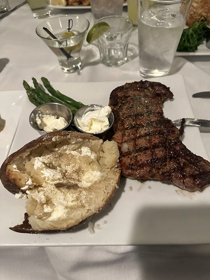This isn't just dinner; it's a masterclass in steak perfection. The loaded baked potato and asparagus know they're in the presence of greatness.