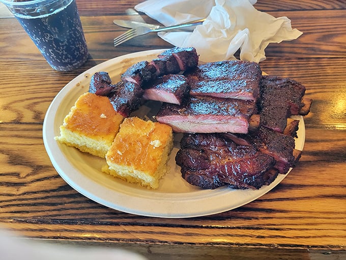 Behold the holy trinity of barbecue: ribs with that perfect bark, smoke ring that would make Saturn jealous, and cornbread that grandma would approve.