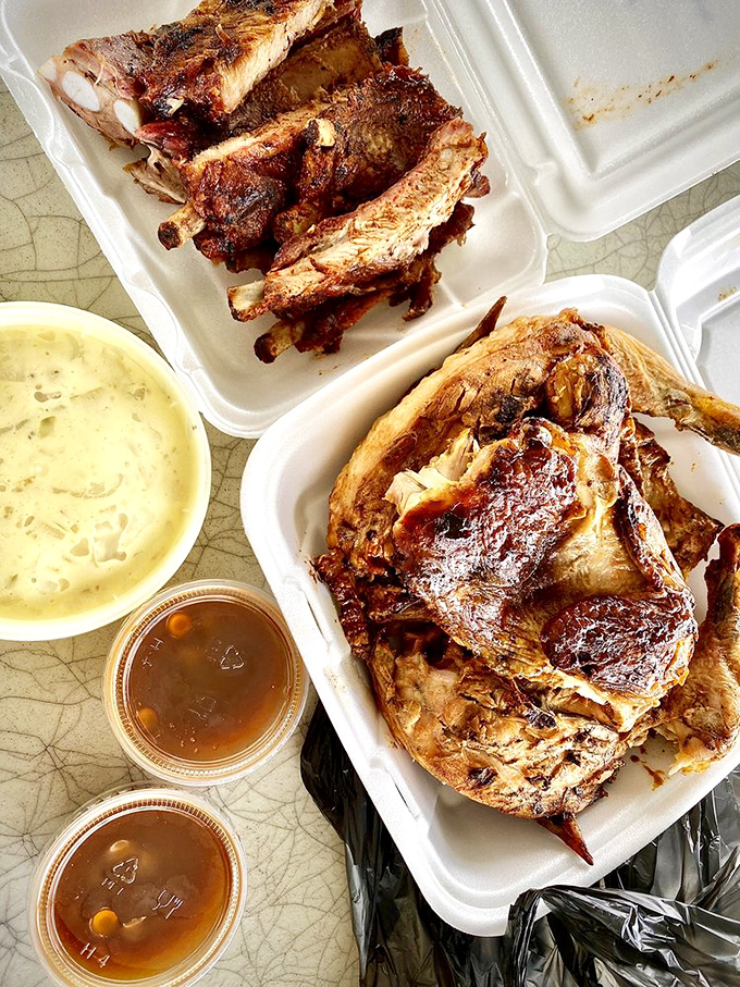 Barbecue nirvana on a styrofoam throne. That bark on the ribs and glistening chicken skin are sending smoke signals straight to my soul.