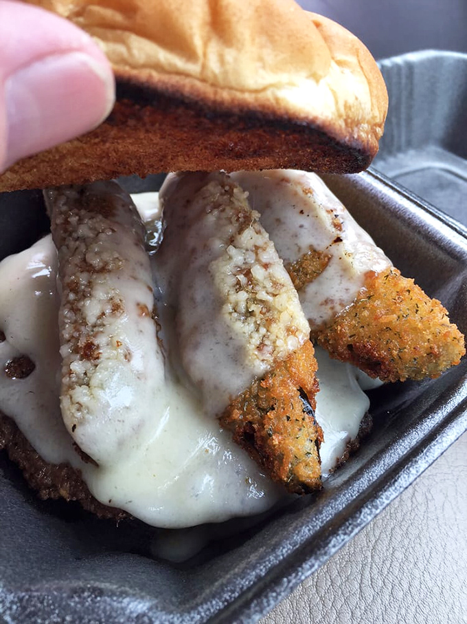 This chicken sandwich means business&mdash;melted cheese cascading over golden-brown breading like a dairy waterfall destined for your taste buds.