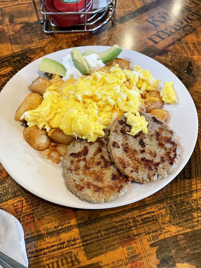 Morning protein perfection: scrambled eggs that look like golden clouds next to perfectly browned turkey sausage patties and potatoes that mean business.