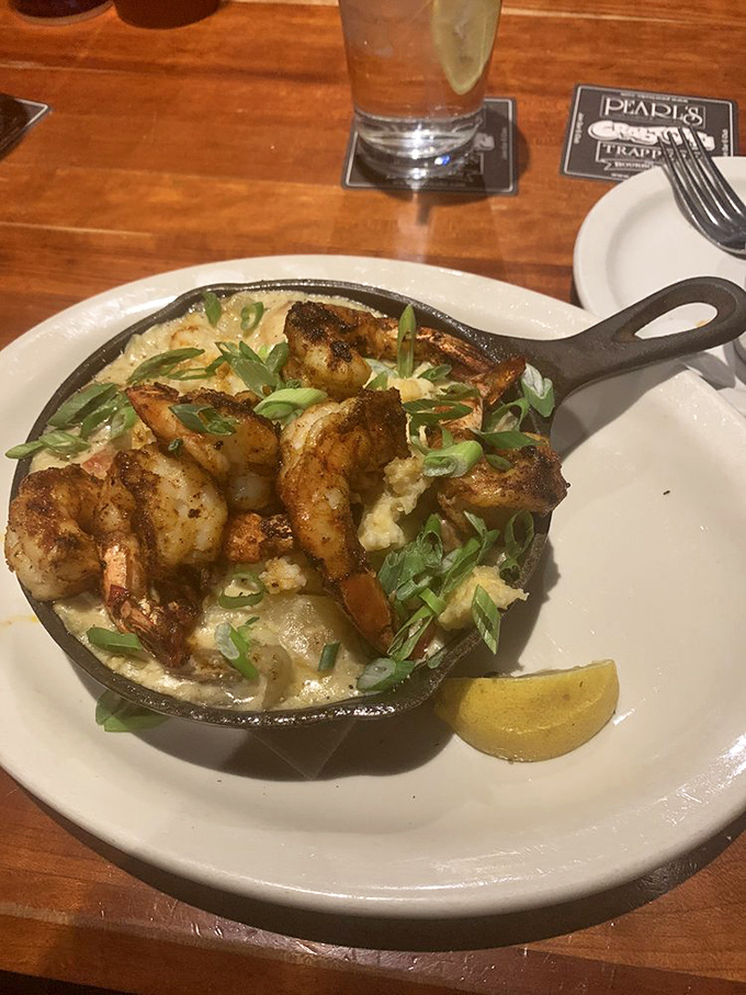 The legendary shrimp and grits arrive sizzling in a cast-iron skillet. That steam rising? It's actually applause from your taste buds.
