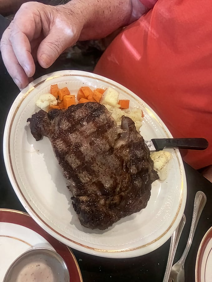 Behold the star attraction: a perfectly grilled ribeye that makes vegetarians question their life choices. Those grill marks aren't just decoration&mdash;they're badges of honor.
