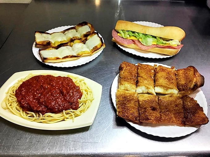 The holy trinity of comfort: spaghetti with meat sauce, garlic cheese bread that could make a vampire rethink its life choices, and a sub that doesn't need fancy aioli to impress.