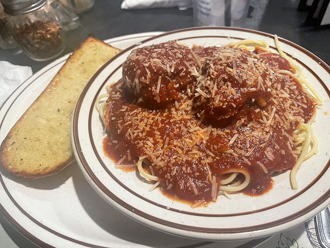 Those meatballs aren't just sharing the plate with spaghetti – they're having a full-blown romance with that perfectly simmered marinara and shower of fresh parmesan.