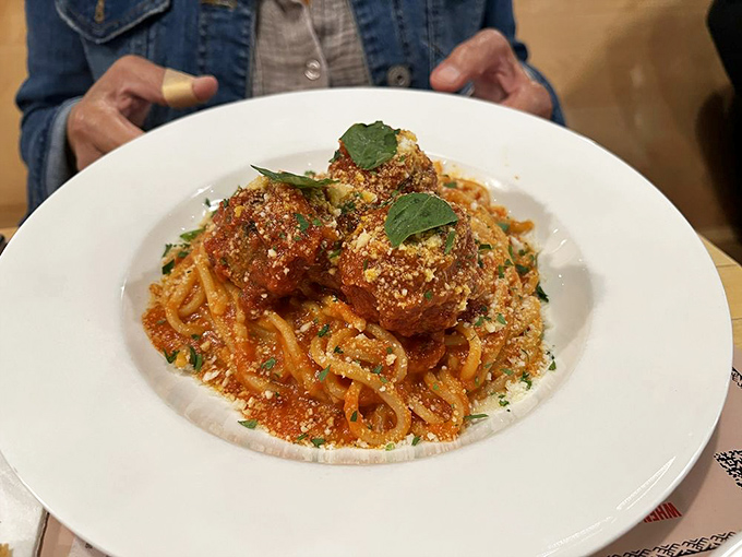 These meatballs don't just sit on the pasta&mdash;they reign supreme, like tiny kings atop their saucy, twirly throne.