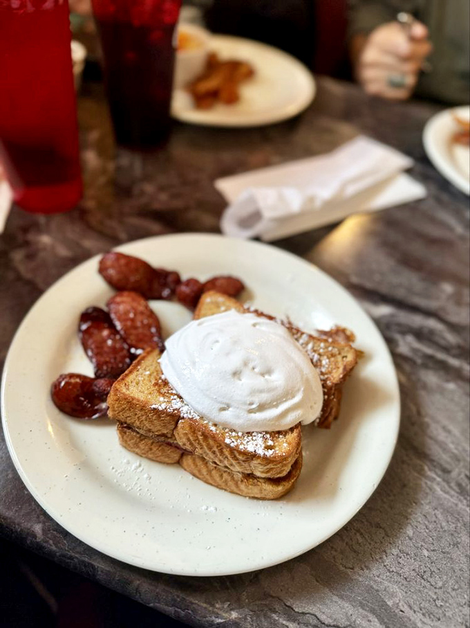 French toast that's dressed up for the occasion, complete with powdered sugar "confetti" and a dollop of whipped cream that means business.