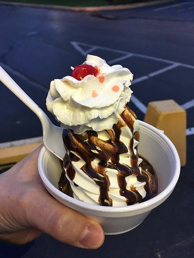 Hot fudge cascading over vanilla soft serve like a chocolate waterfall. The cherry on top isn't just a garnish&mdash;it's the exclamation point.