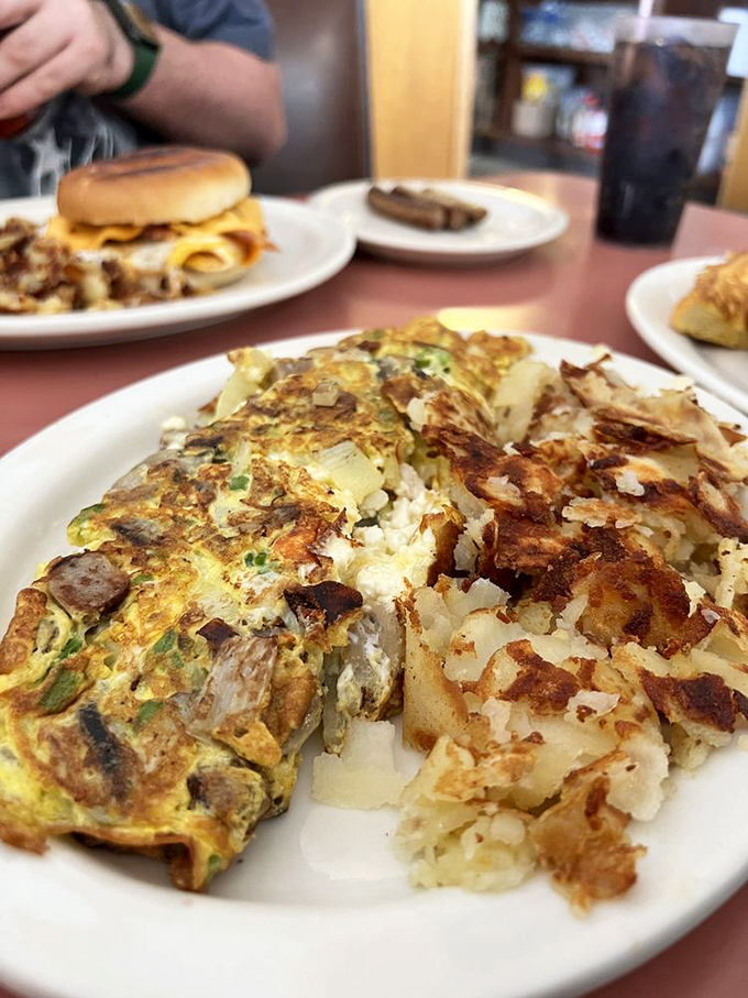 Breakfast alchemy at its finest&mdash;a veggie-packed omelet nestled against hash browns with that perfect crisp-to-tender ratio.