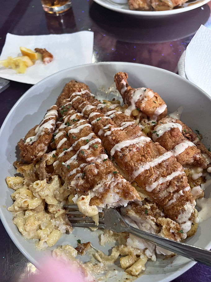 Crispy fried chicken atop creamy mac and cheese&mdash;a combination so perfect it should have its own national holiday. Soul food architecture at its finest.