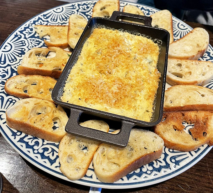 This isn't just dip, it's a warm bath of bourbon-caramelized goodness surrounded by a crispy bread chip entourage.